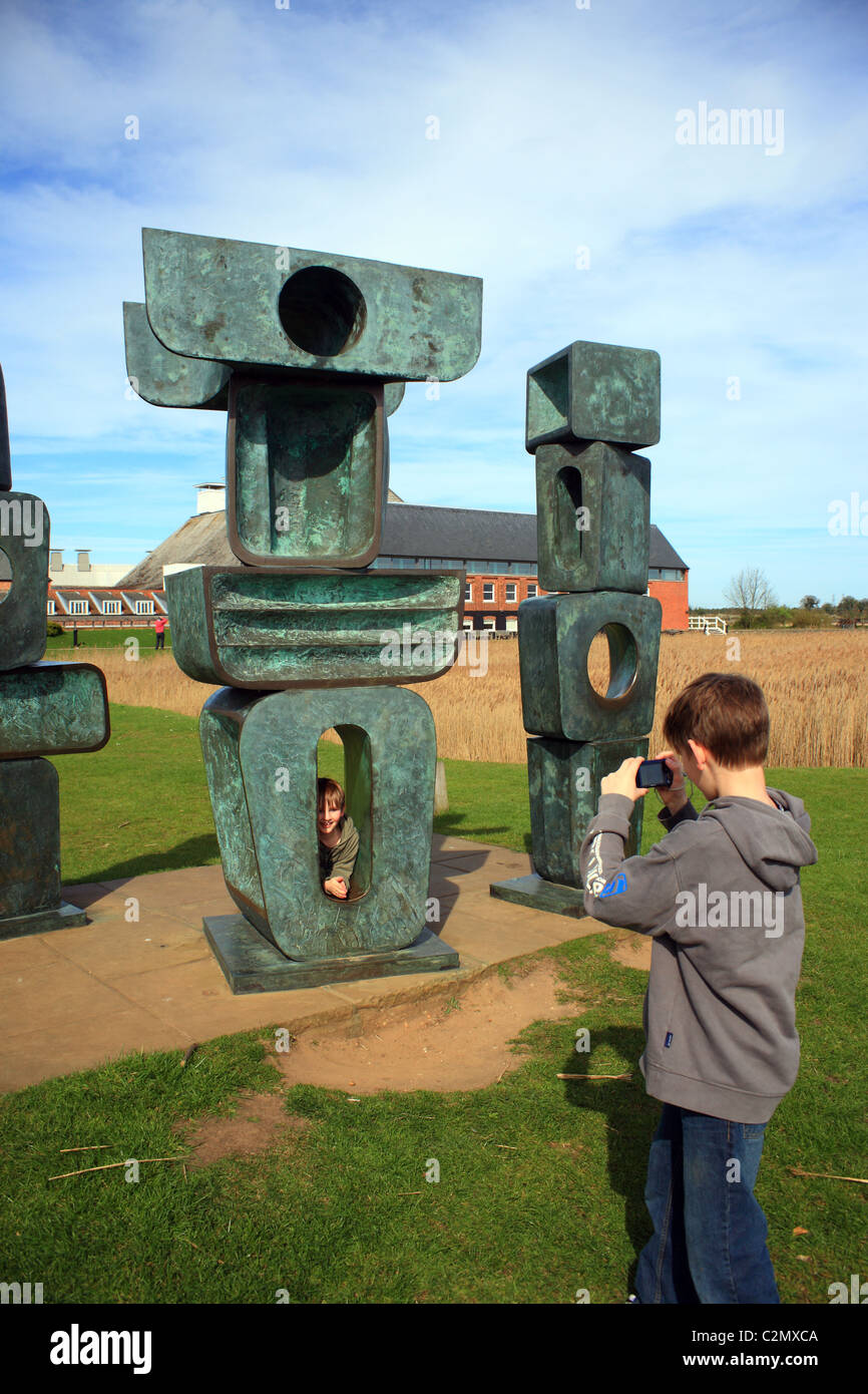 Boy photographing his brother through outdoor sculpture at Snape ...