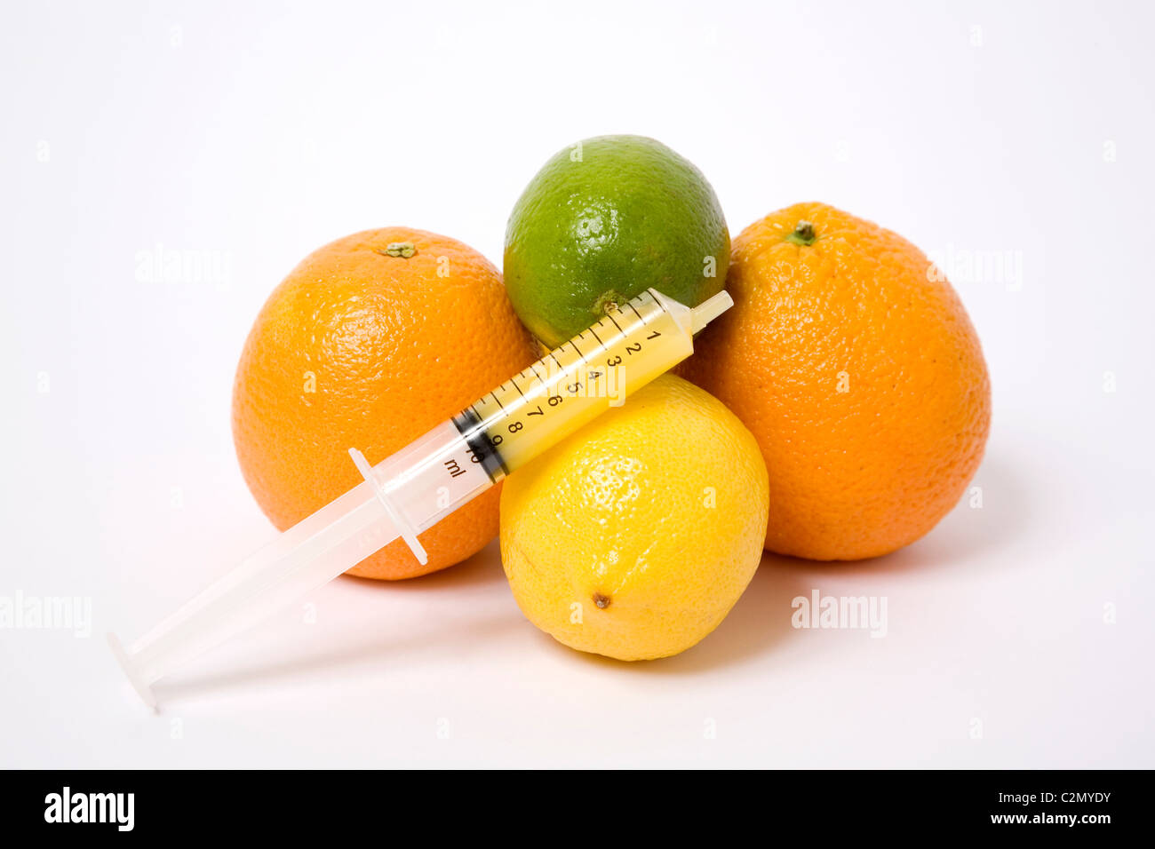 Citrus fruit with syringe filled with juice - vit C dose Stock Photo ...