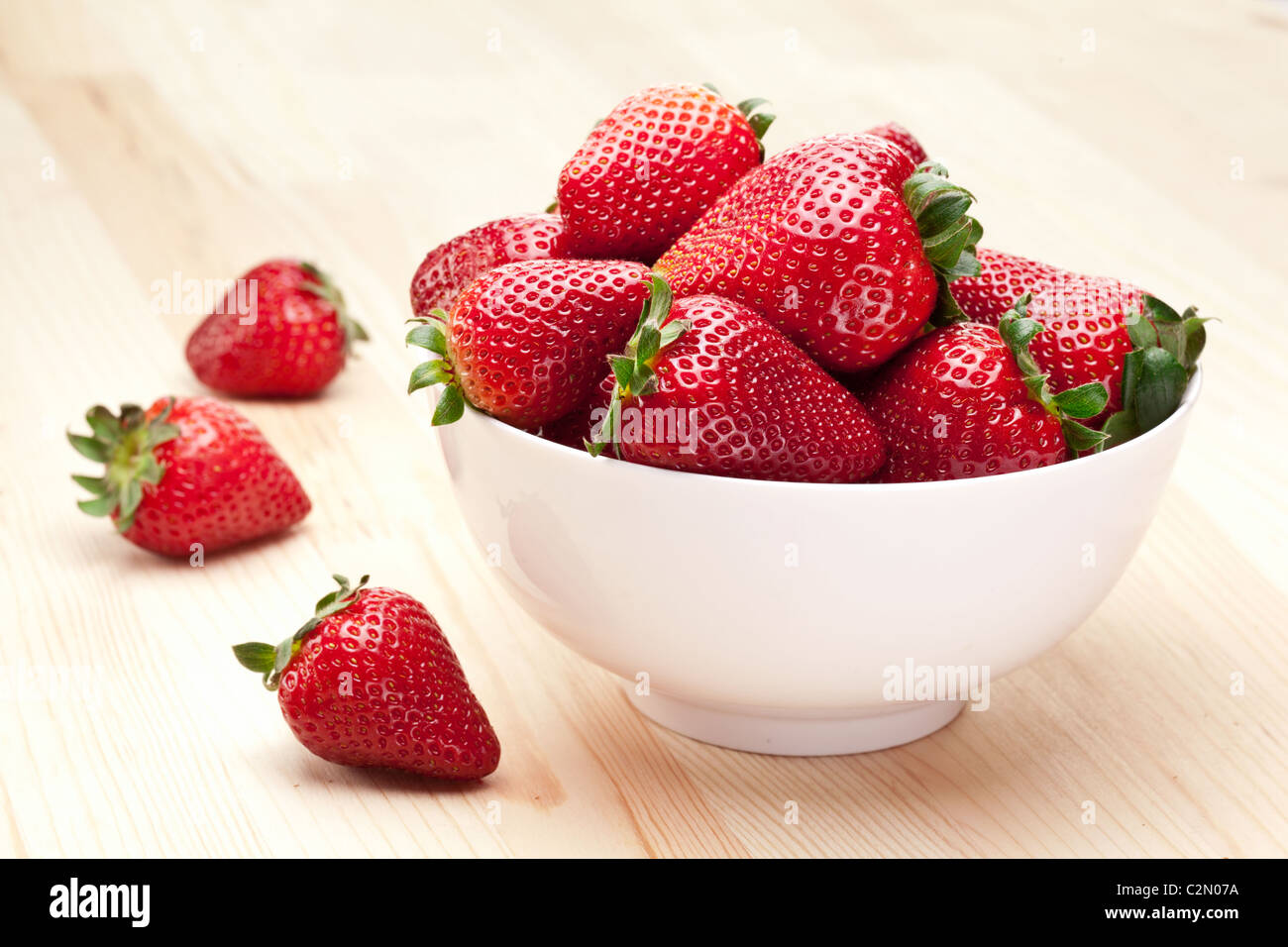Appetizing strawberry in the bowl. Isolated on a white background Stock ...