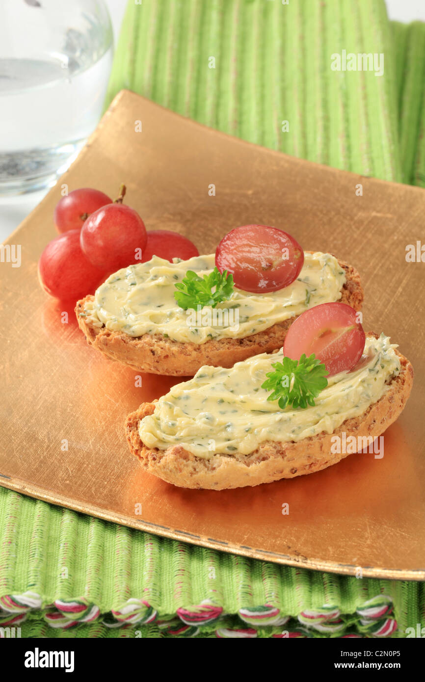 Whole wheat crispy rolls and herb butter Stock Photo - Alamy