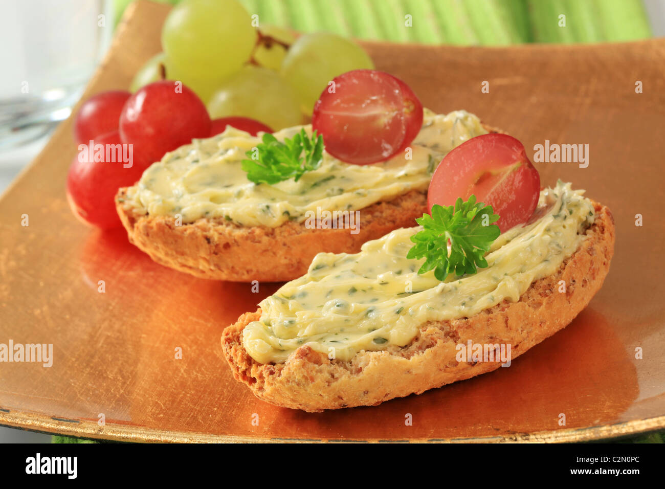 Whole wheat crispy rolls and herb butter Stock Photo - Alamy