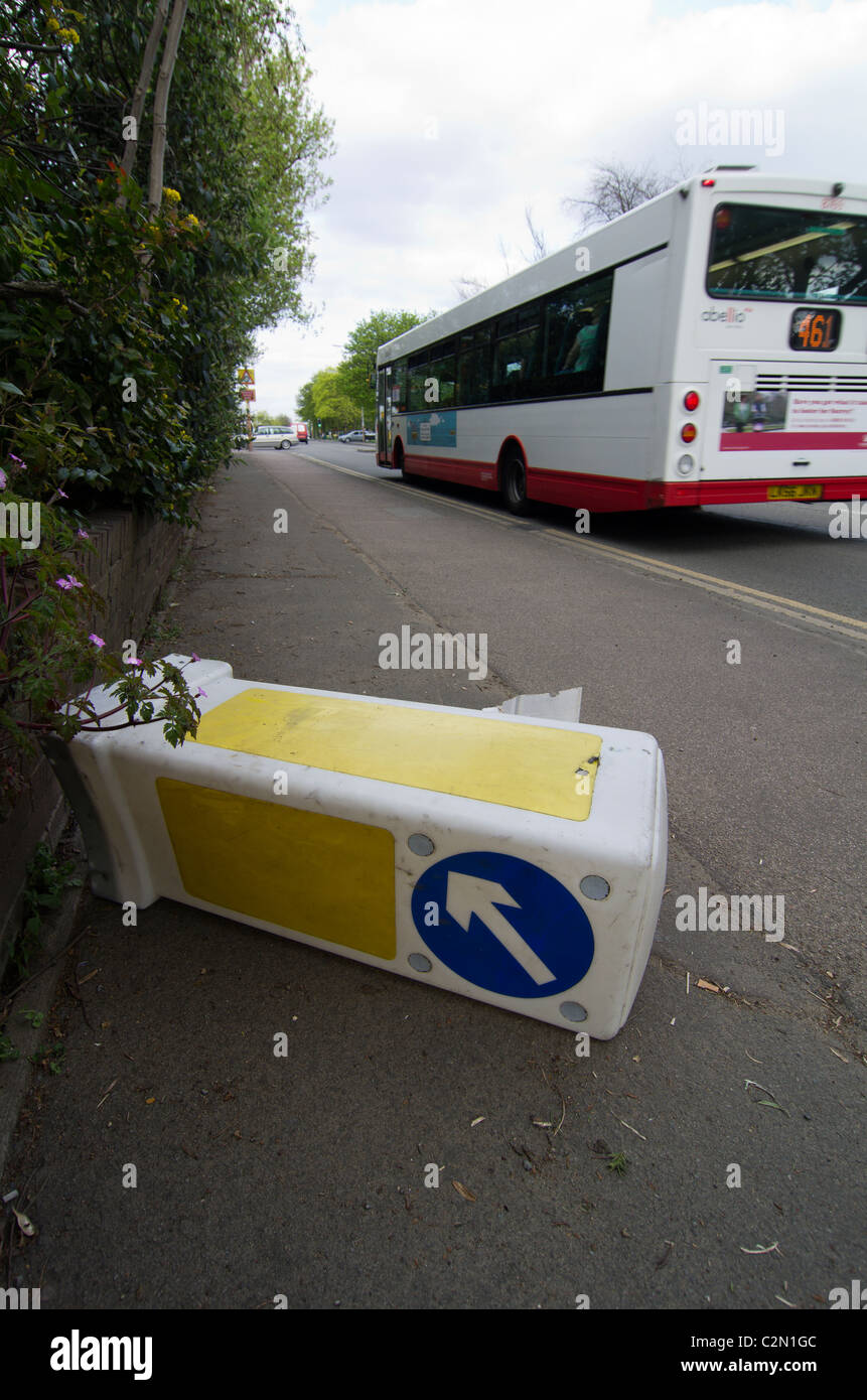 a knocked over and broken traffic bollard lies on the pavement Stock ...