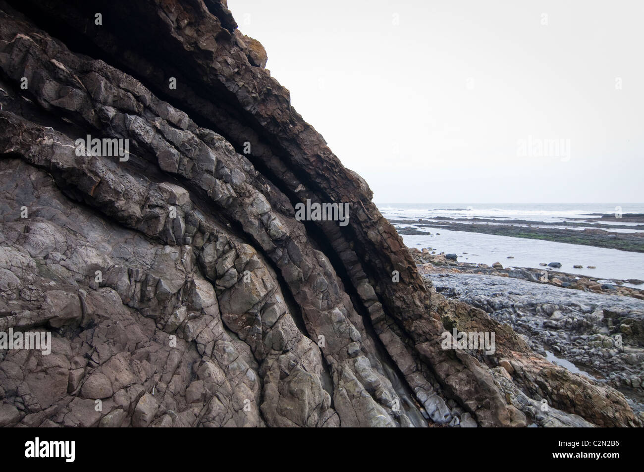 Volcanic magma rock formation at Cocklawburn, Northumberland, England ...