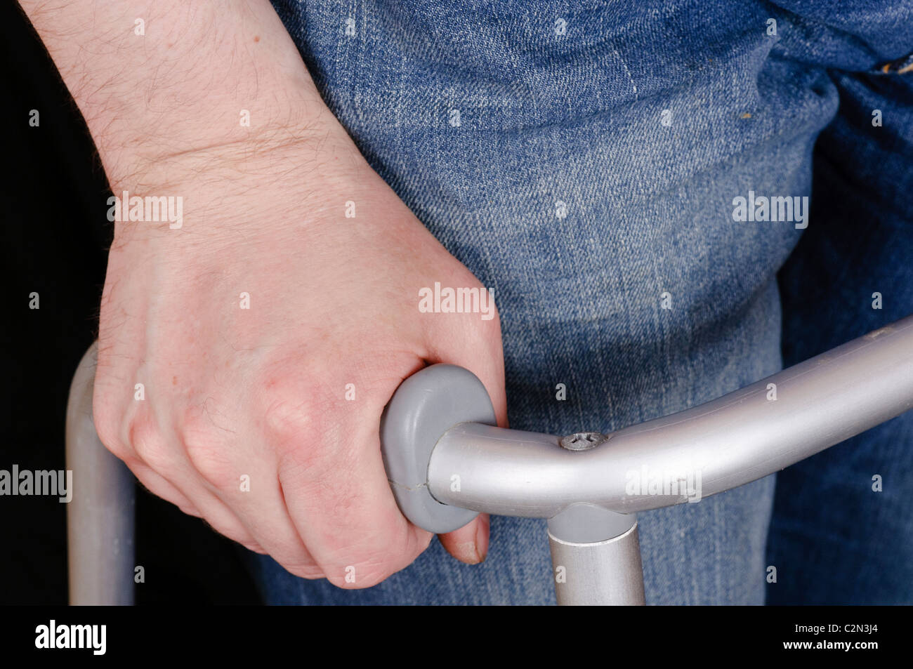 Man in his 40's using a walking assistance frame due to inability to ...