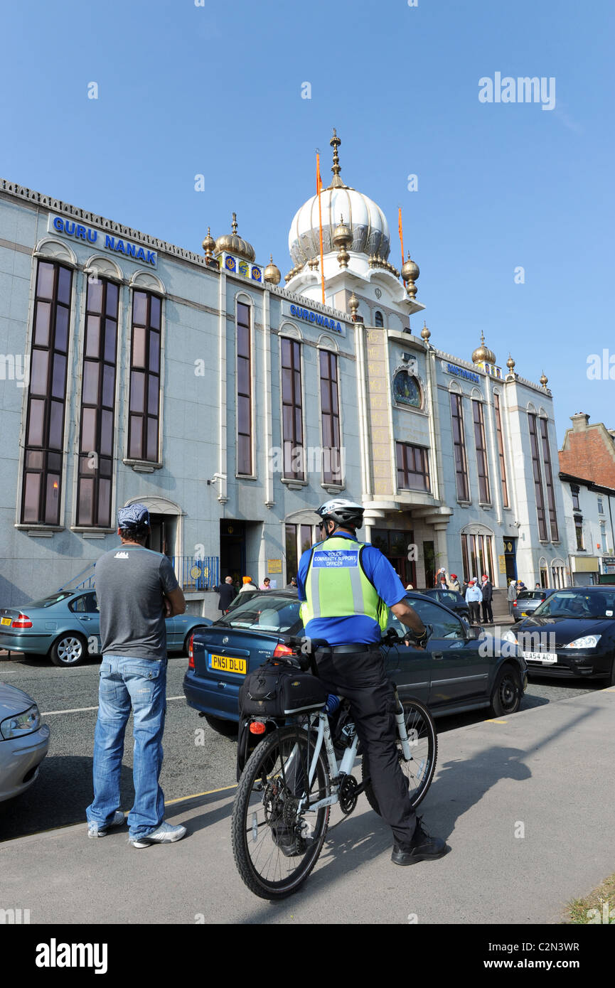 An Asian Police Community Support Officer on duty outside Guru Nanak ...