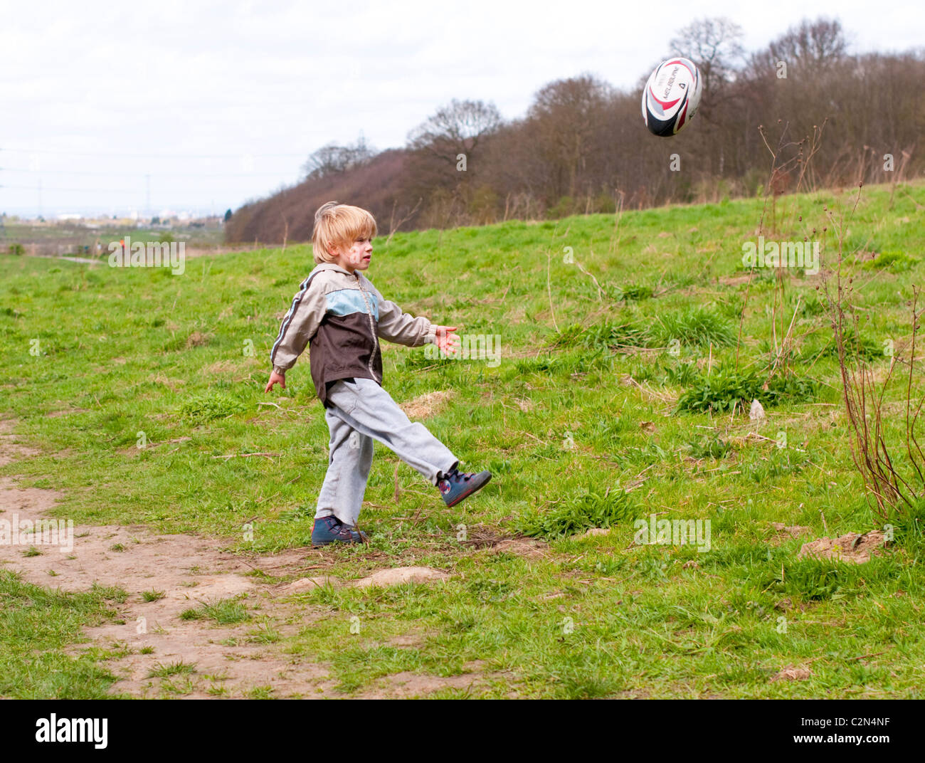 Young boy playing rugby Stock Photo - Alamy