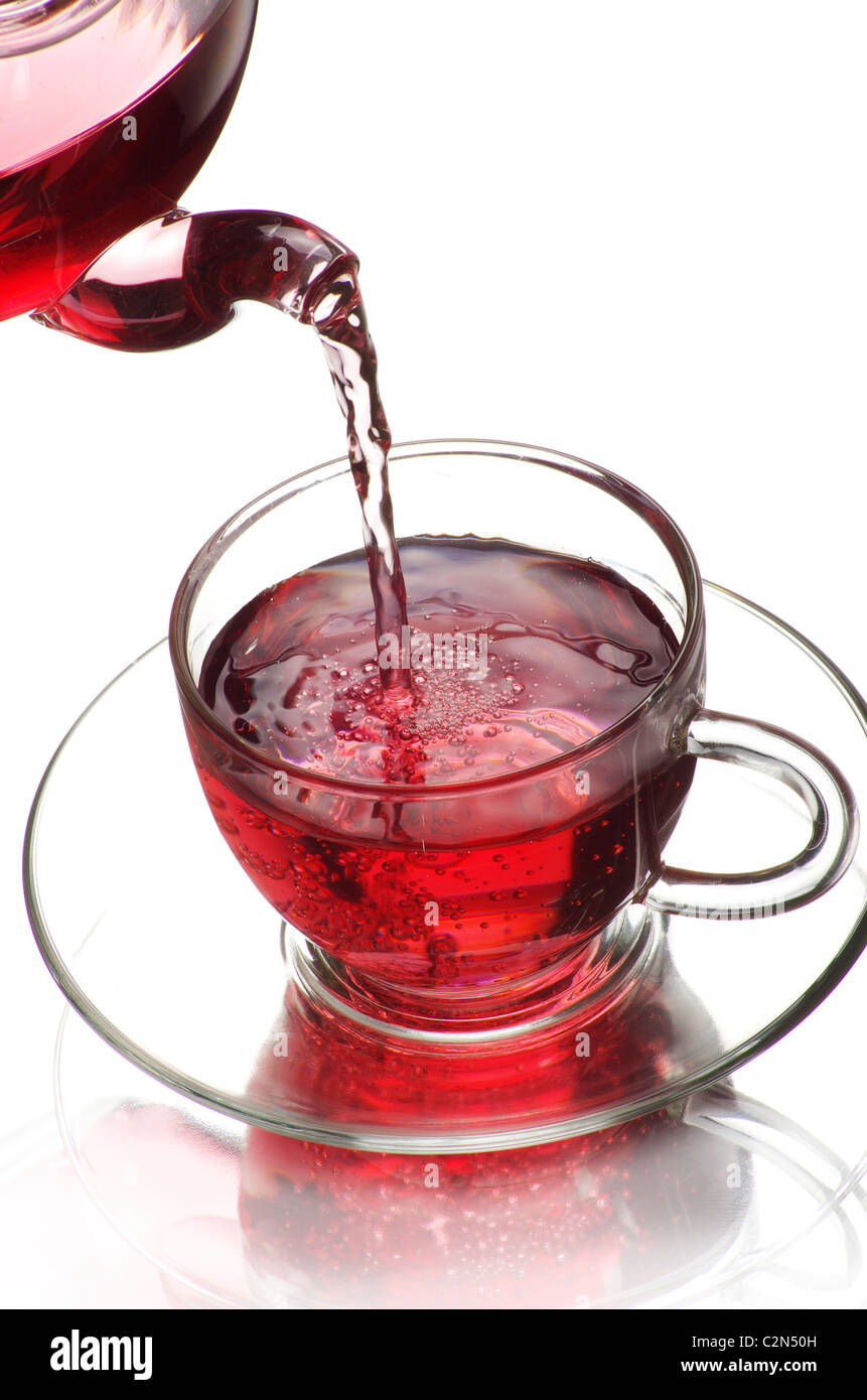 Tea being poured into glass tea cup Stock Photo - Alamy