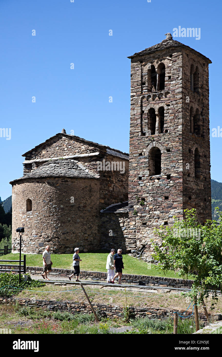 People walking past ancient church Sant Joan de Caselles Andorra Stock ...
