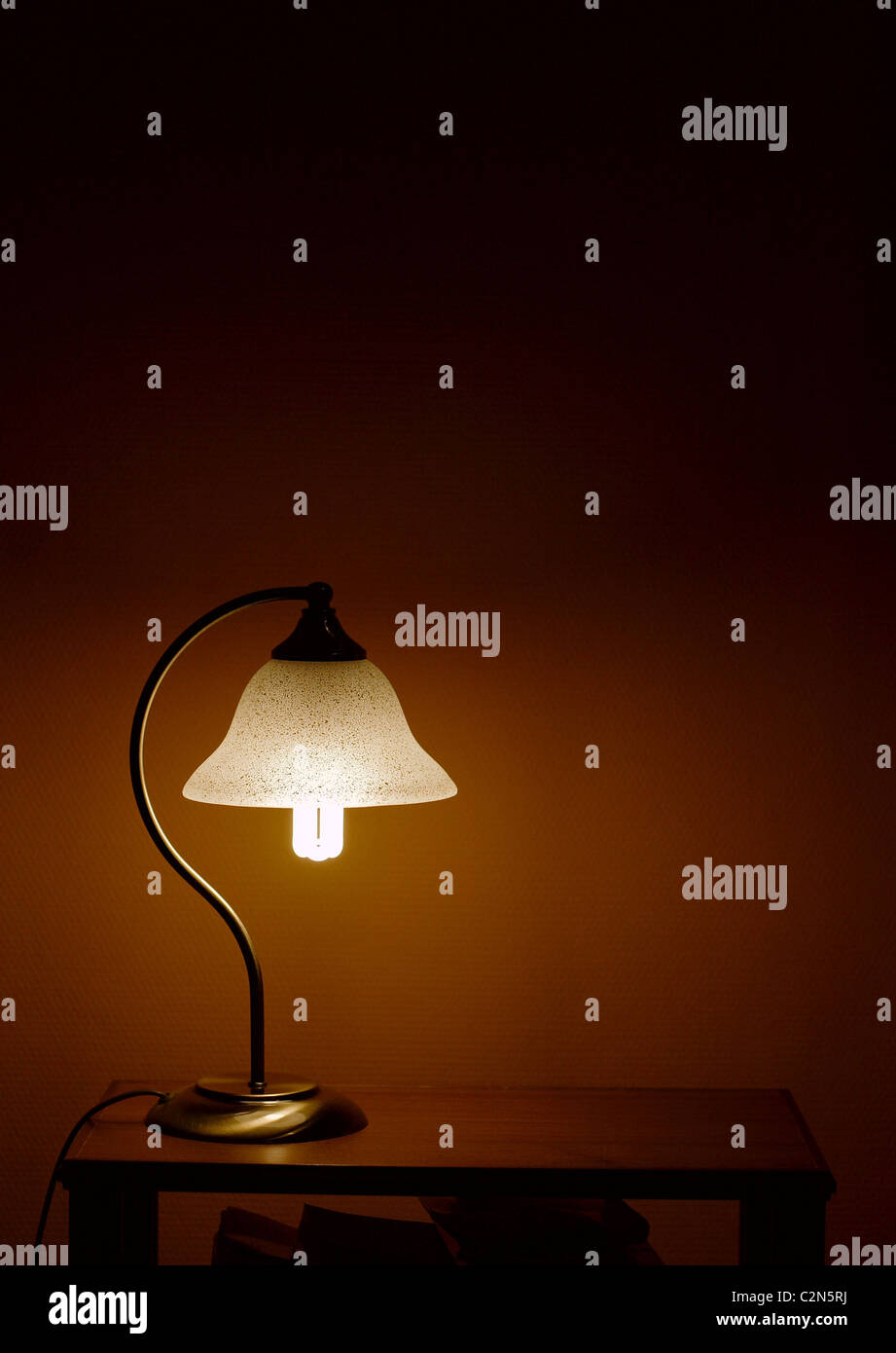 Lamp on a table illuminating the night Stock Photo - Alamy