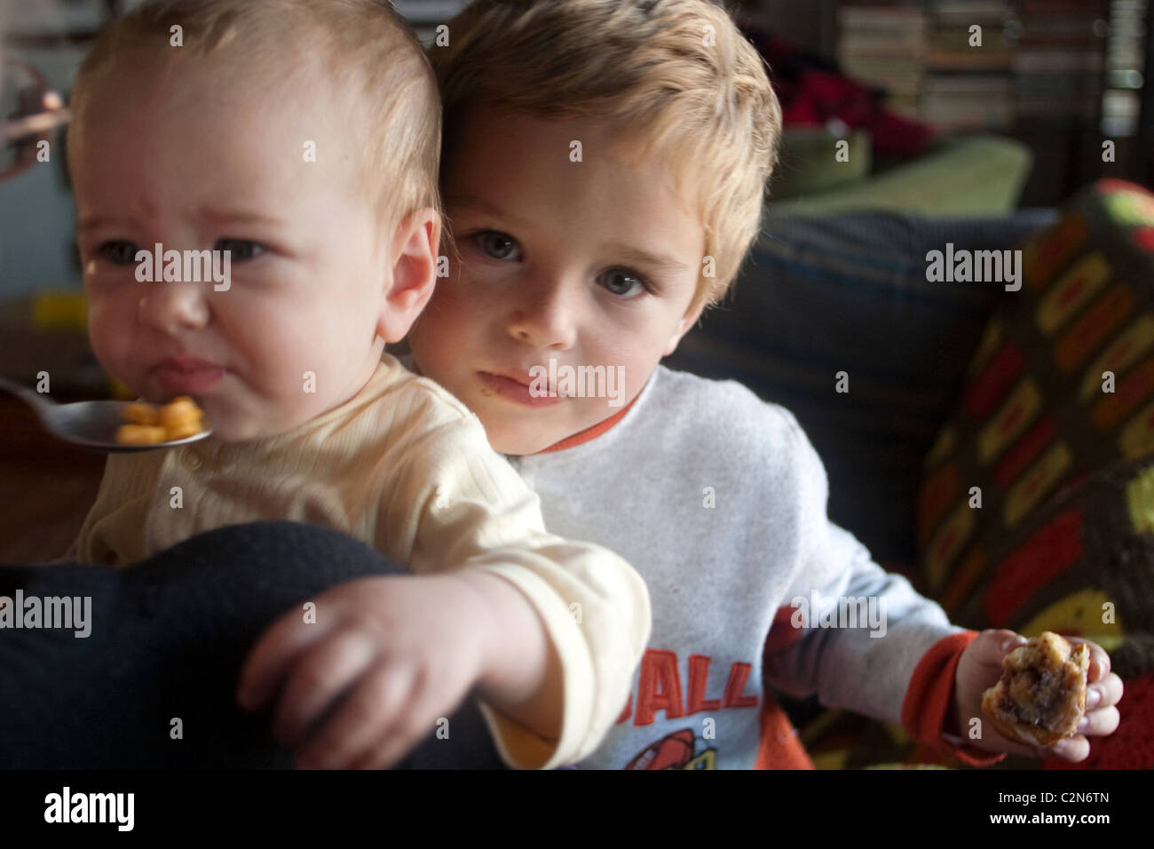 A 6 year old boy plays with his baby brother at a restaurant Stock ...