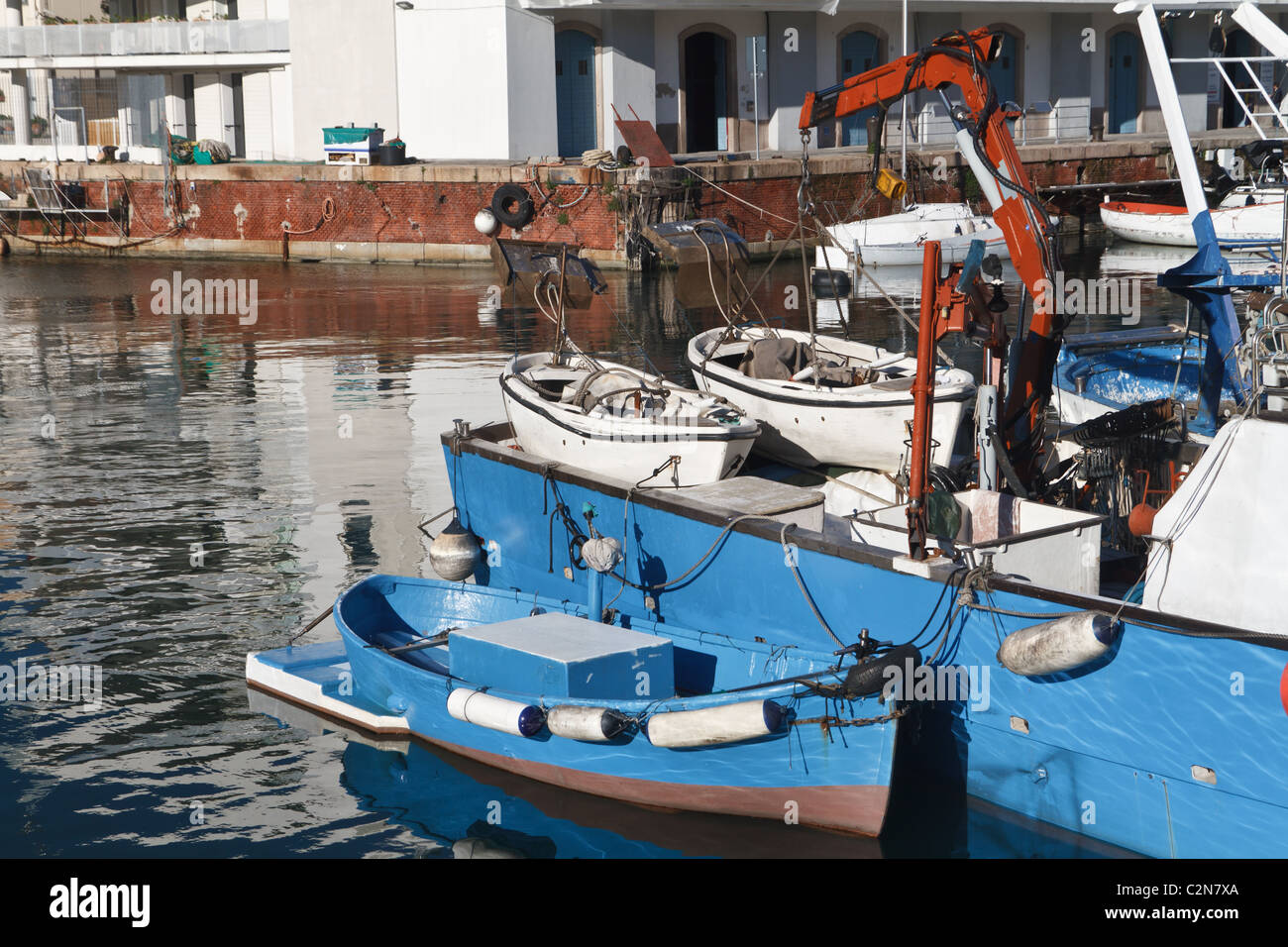 dock with fishing boat in Genova harbor, Italy Stock Photo - Alamy