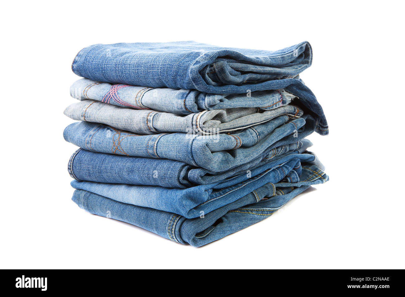 Pile of blue jeans over white background Stock Photo - Alamy