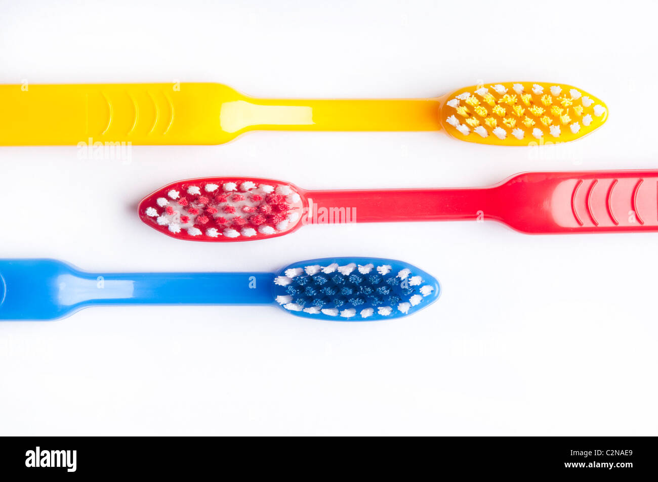 three colorful toothbrushes Stock Photo - Alamy