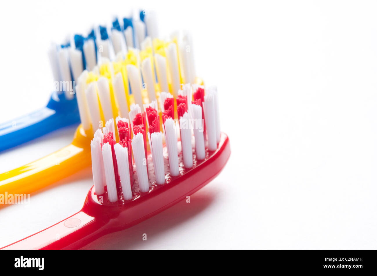 three colorful toothbrushes Stock Photo - Alamy