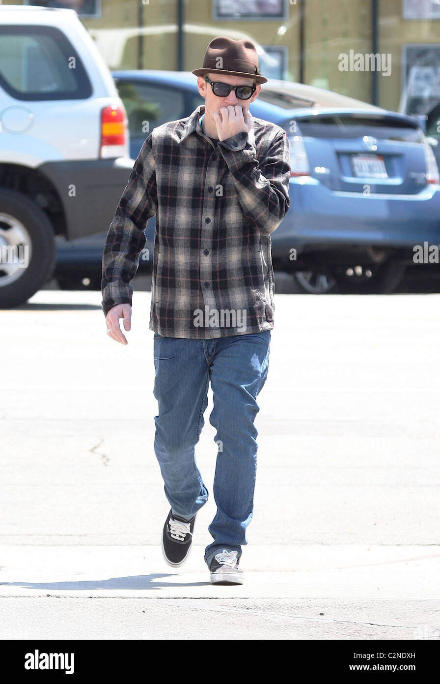 Josh Madden covering his mouth as he heads to LAX airport with his ...