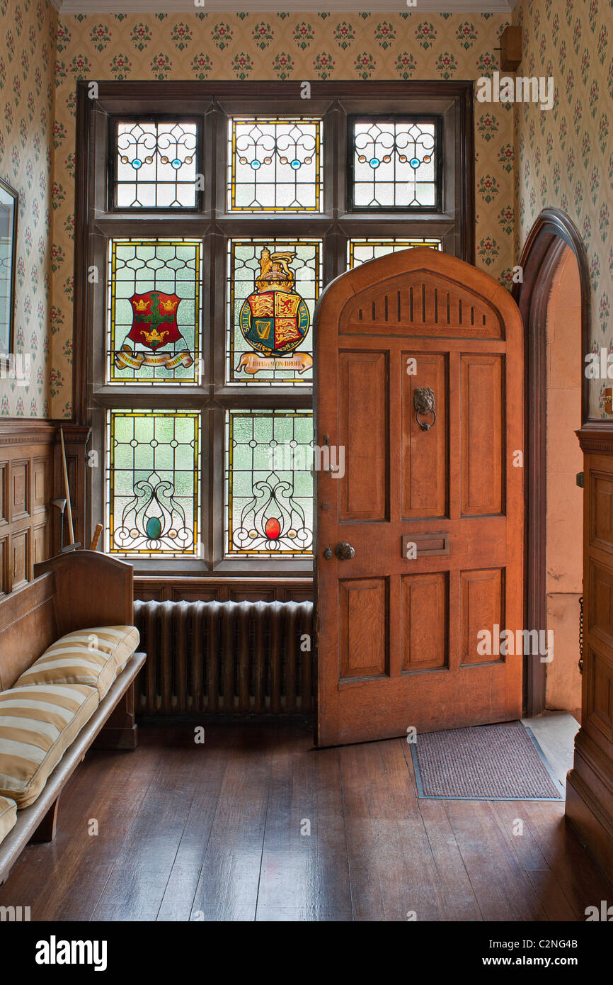 Entrance Hall and stained glass window with heraldic crests, arched ...