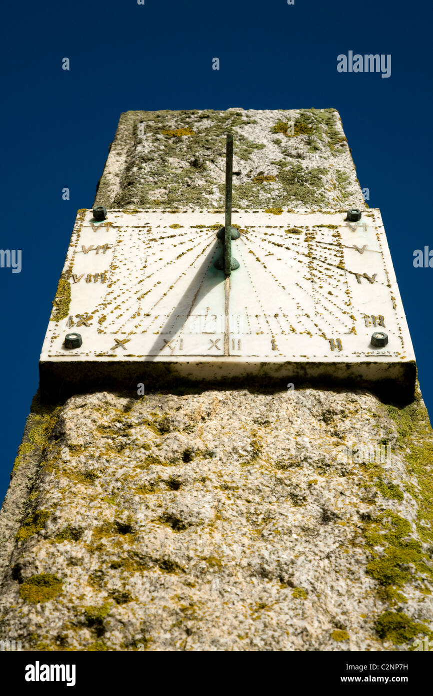Sundial on a sunny day with blue sky and shadow: near to the entrance ...