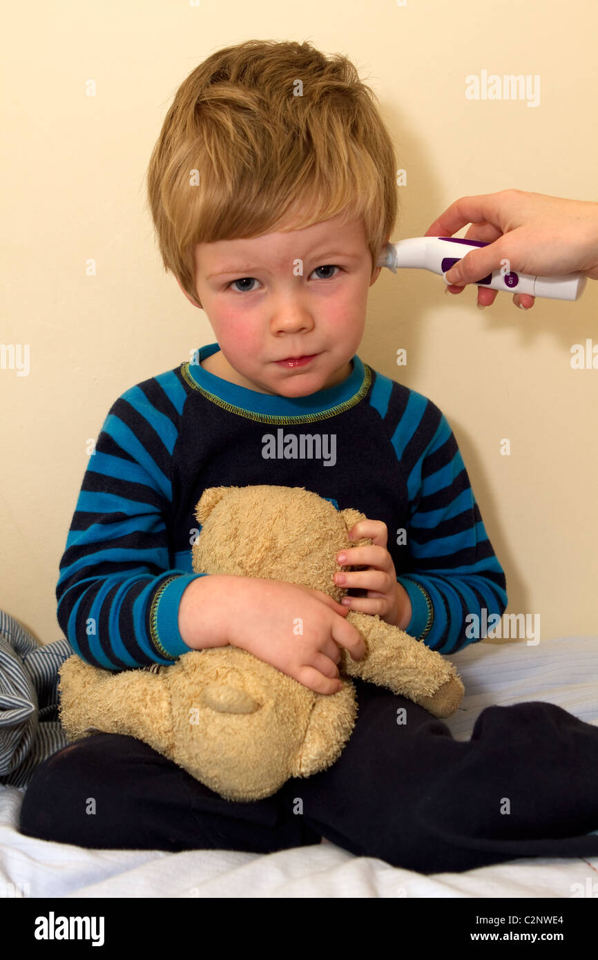 Young boy having his temperature taken Stock Photo - Alamy