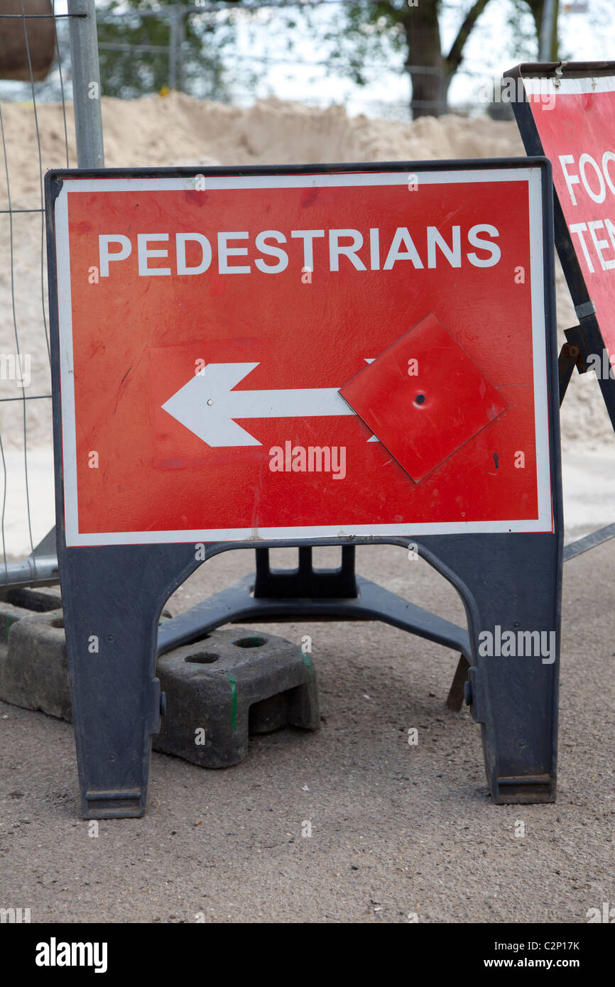 Red sign with white writing and arrow Stock Photo - Alamy