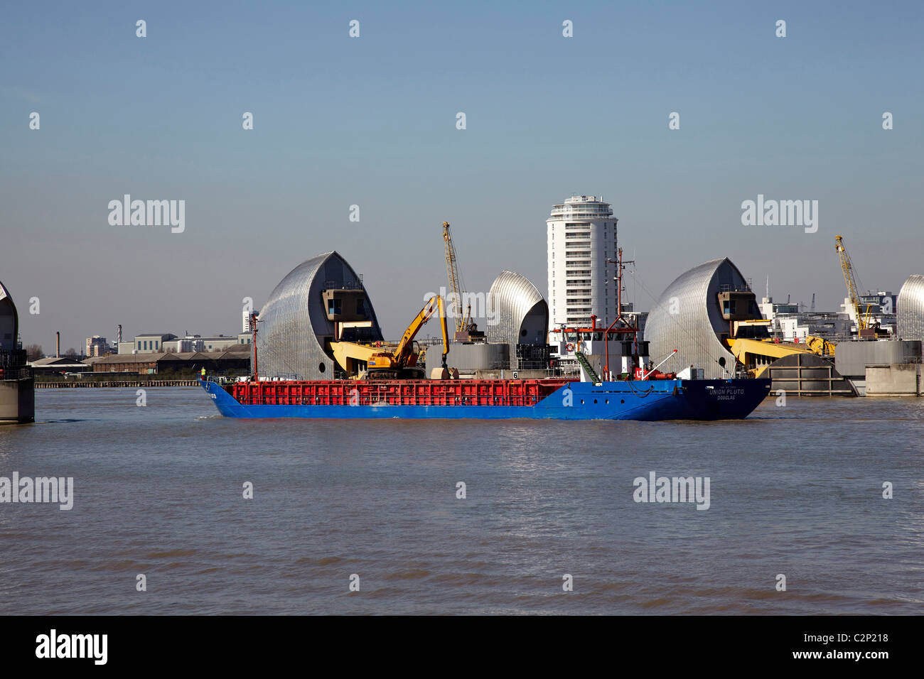 Cargo ship Union Pluto negotiates the Thames barrier at Woolwich Stock ...