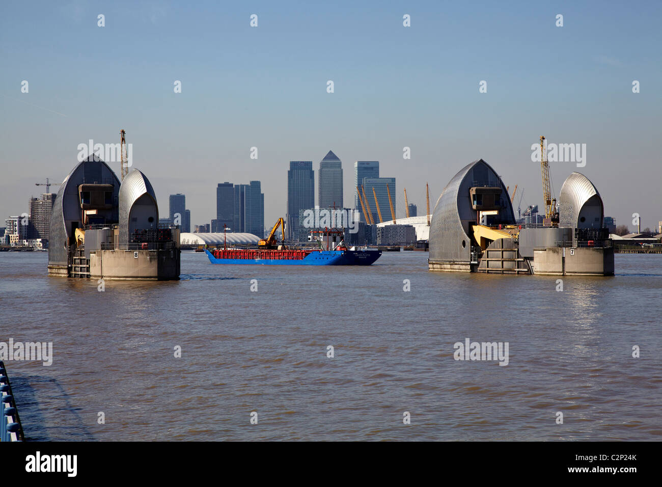 Cargo ship Union Pluto negotiates the Thames barrier at Woolwich Stock ...