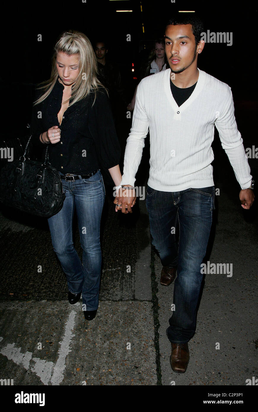 Melanie Slade and Theo Walcott walking along Brick Lane after the ...