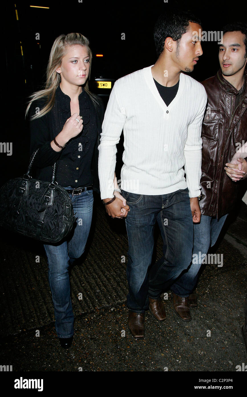Melanie Slade and Theo Walcott walking along Brick Lane after the ...