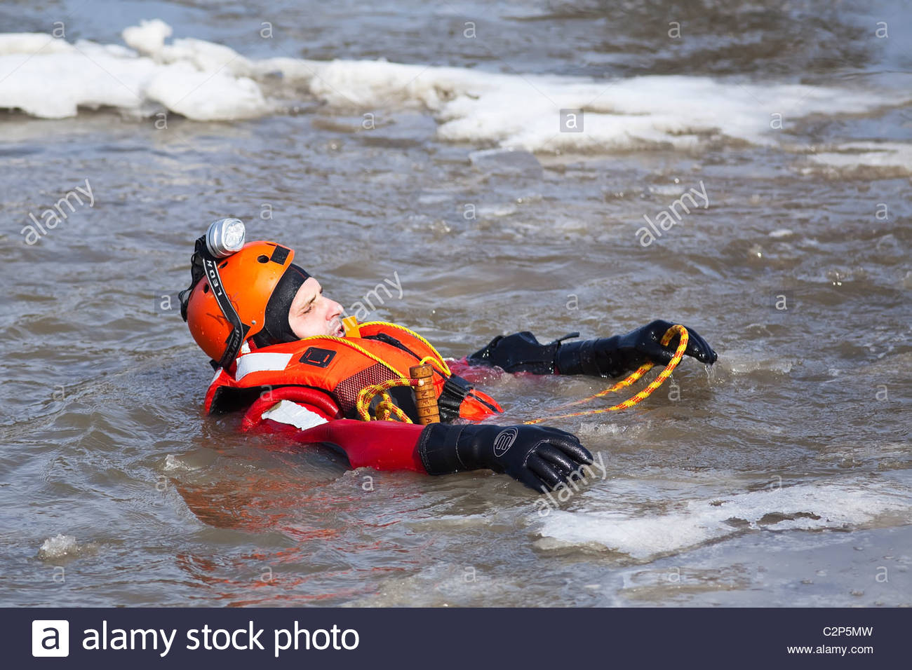 Water rescue worker, wearing a cold water survival suit, floating in ...