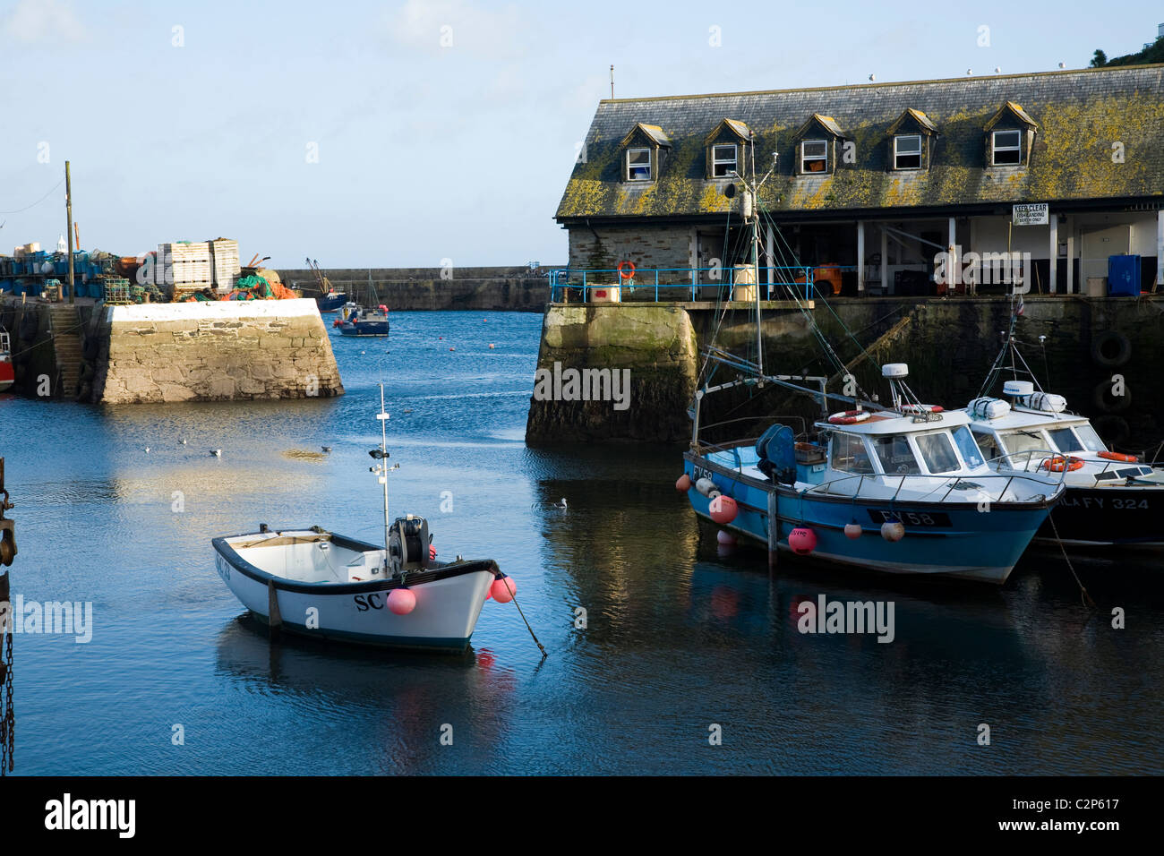 Cornish fishing boats / boat moored at the quay / quayside in the ...