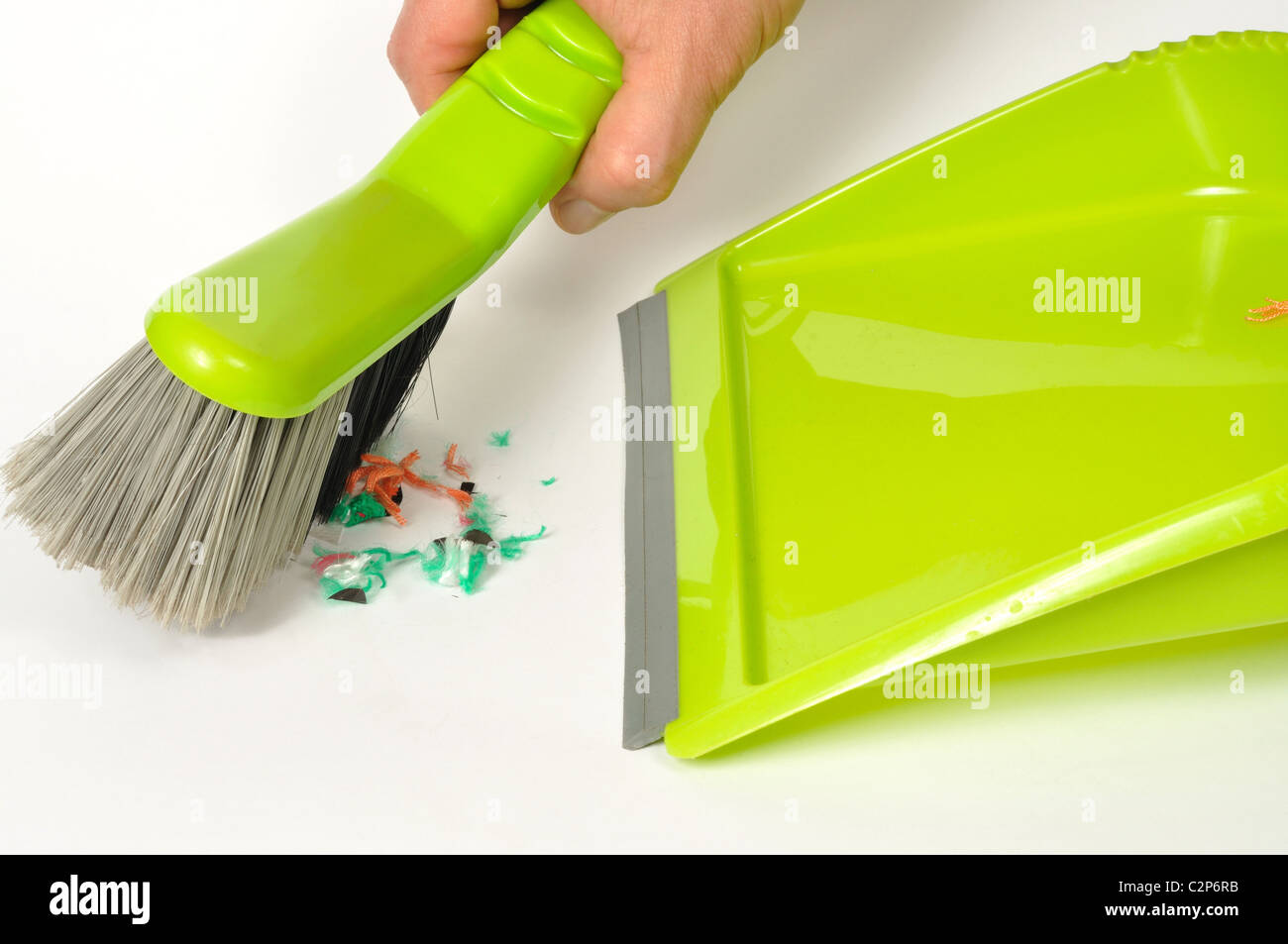 Green brush and dustpan with some garbage on white background Stock ...