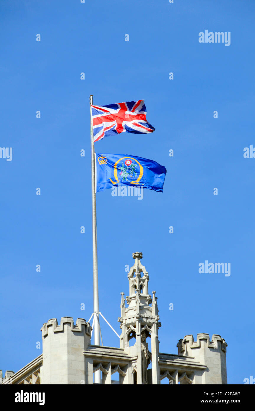 Union Jack & Emblem UKSC flags flying above stone tower old Middlesex ...