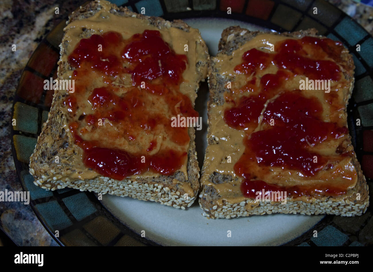 Multi grain toast with peanut butter and jam Stock Photo - Alamy
