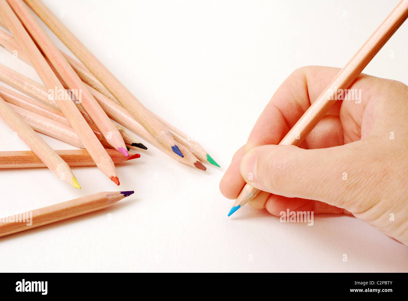 human hand ready to write with color pencils Stock Photo - Alamy