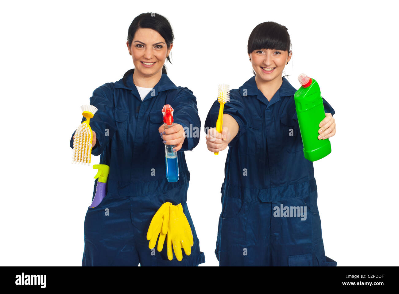 Happy workers women in uniform showing cleaning products isolated on ...