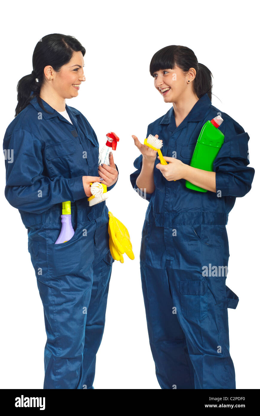 Two happy cleaning workers women having conversation and holding ...