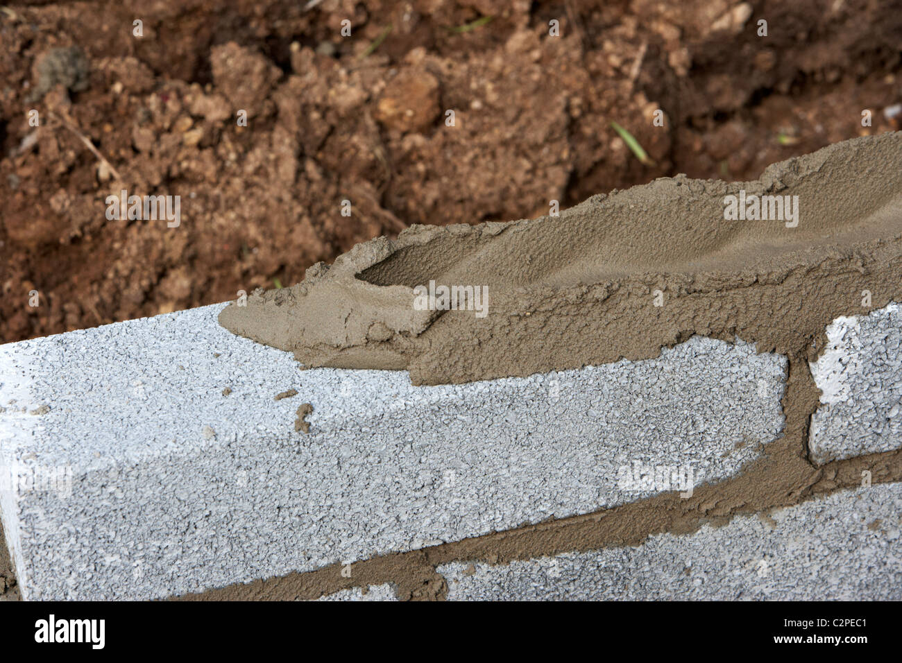 bricklaying wall with half cement breeze blocks building a block ...
