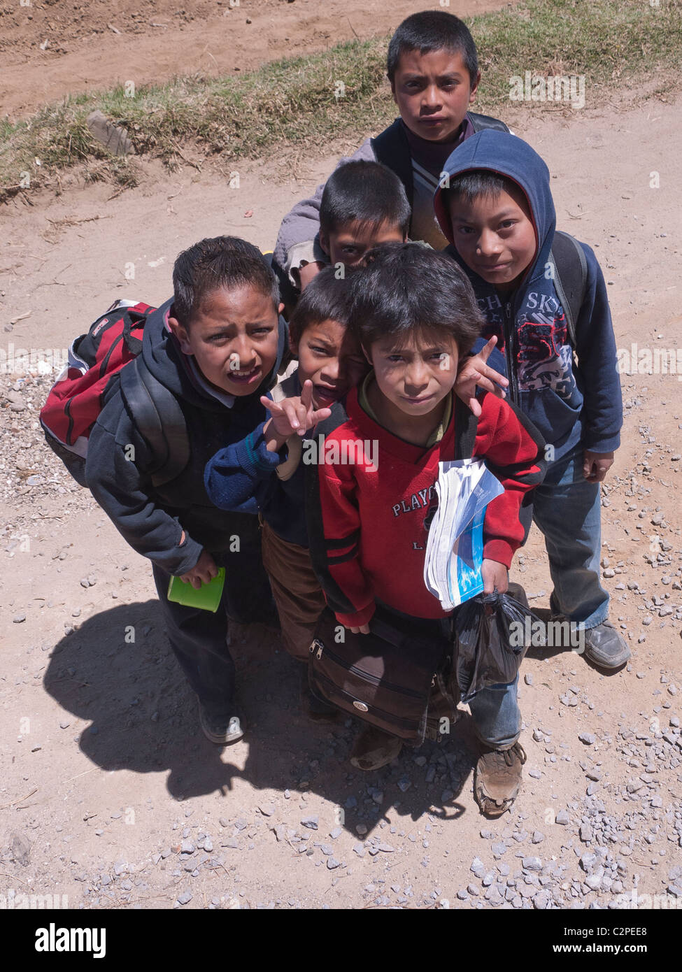 A group of young Guatemalan school boys make funny faces for the camera ...