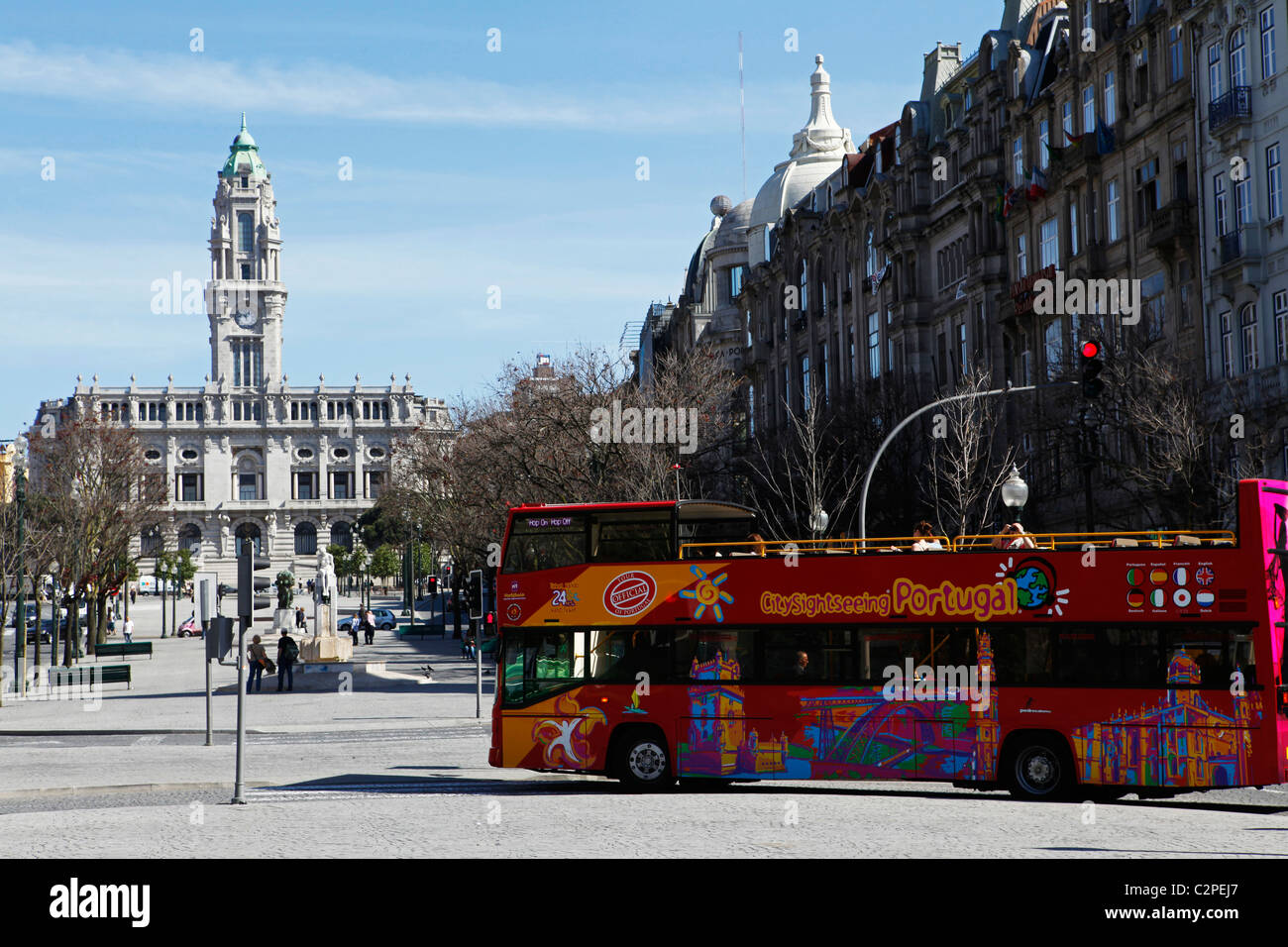A double decker City Sightseeing Bus tours through central Porto ...