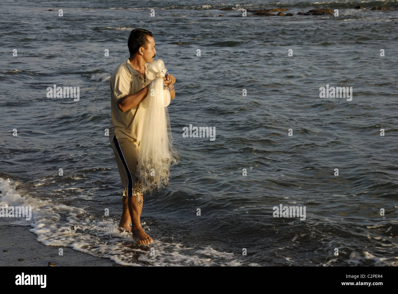 Fishing with cast net - Bali, Indonesia Stock Photo - Alamy