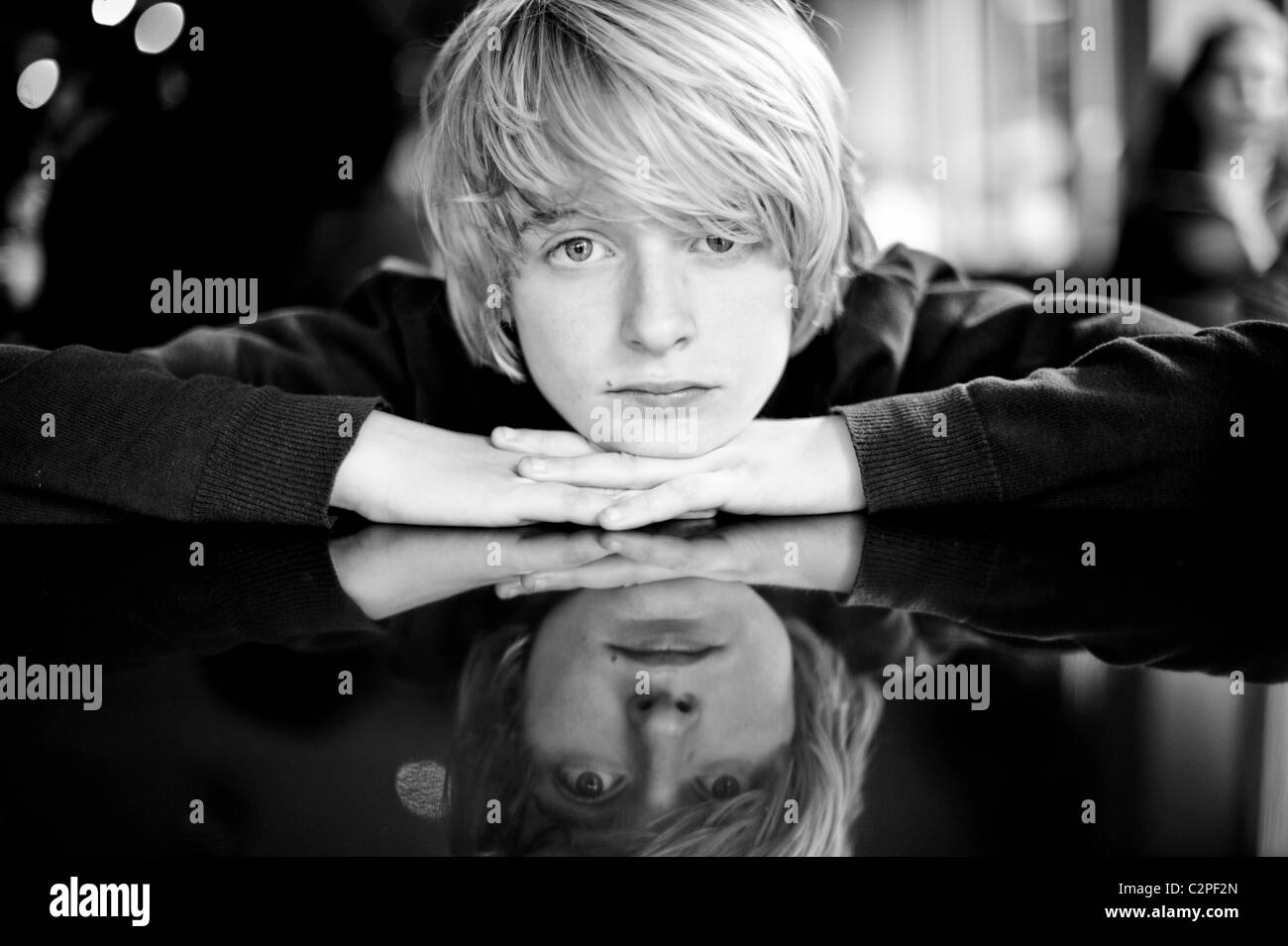 Beautiful romantic dreamy teenage boy with his fair-haired head resting ...