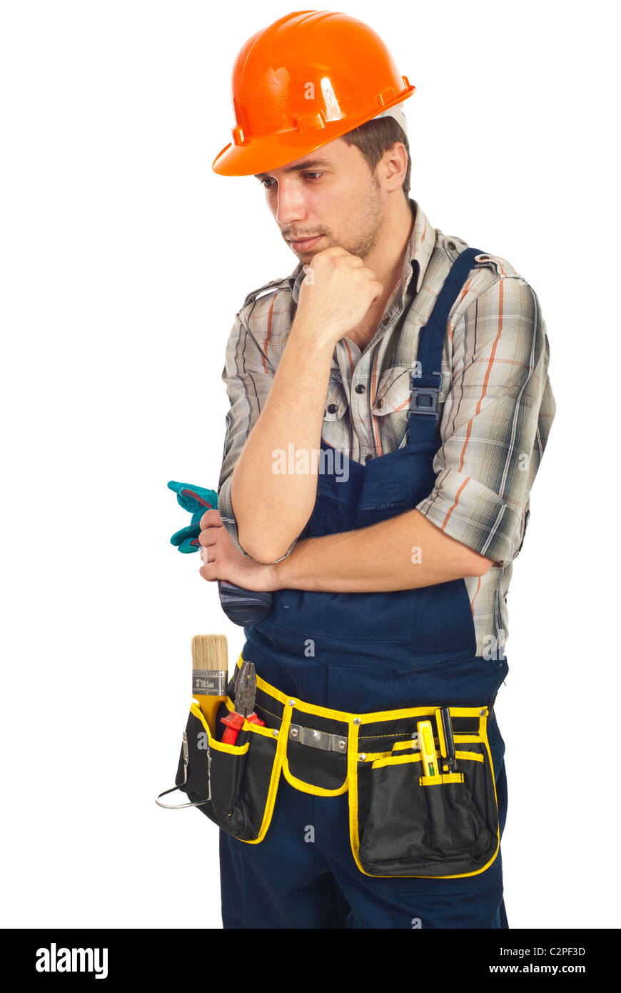 Sad young workman looking down and thinking isolated on white ...