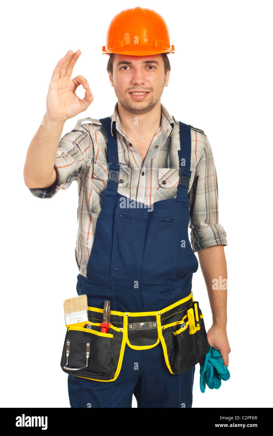 Happy young workman showing okay sign hand gesture isolated on white ...