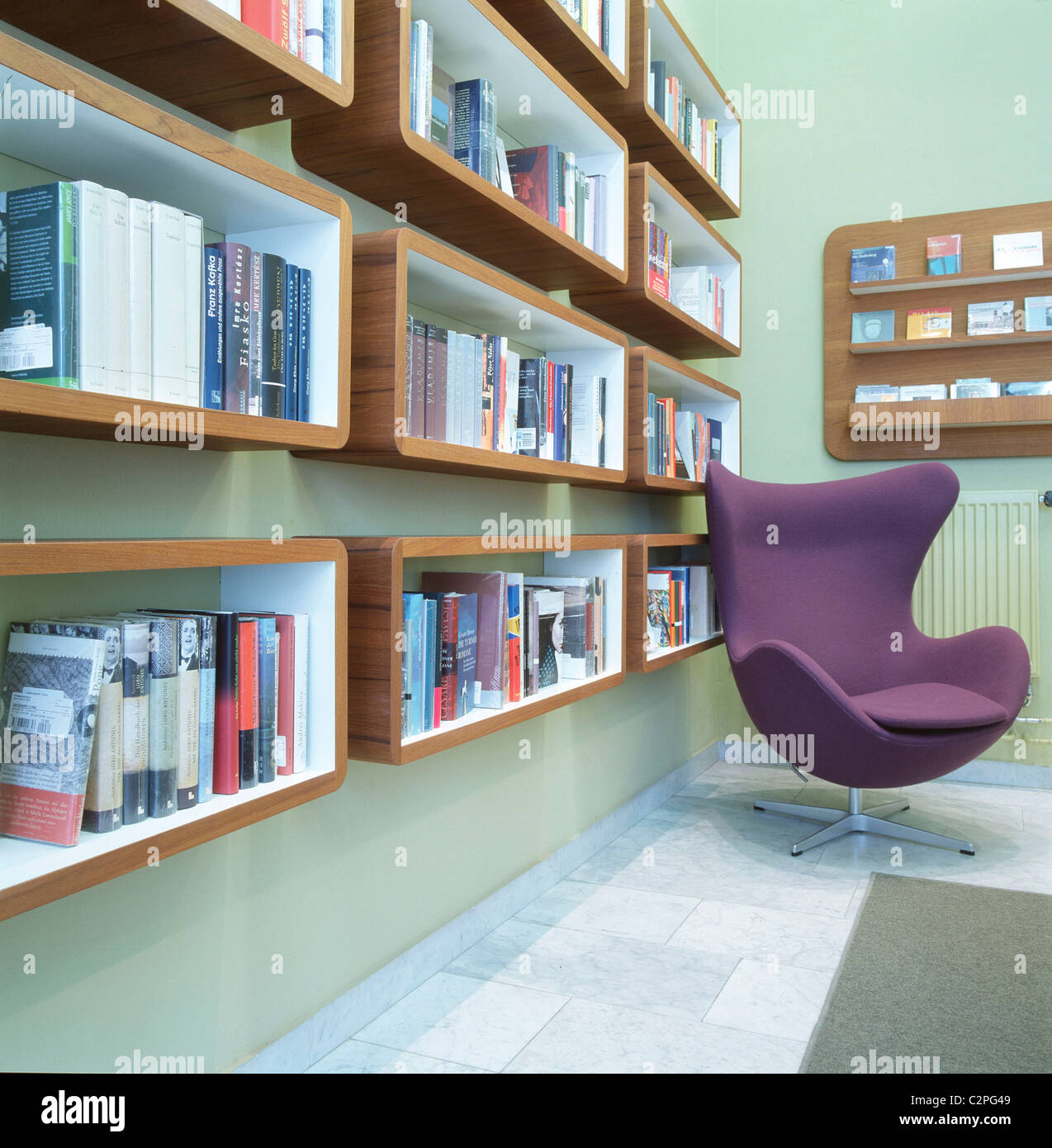 Liebeskind Publishers Bookshop, Munich Germany. Chair by shelves in ...