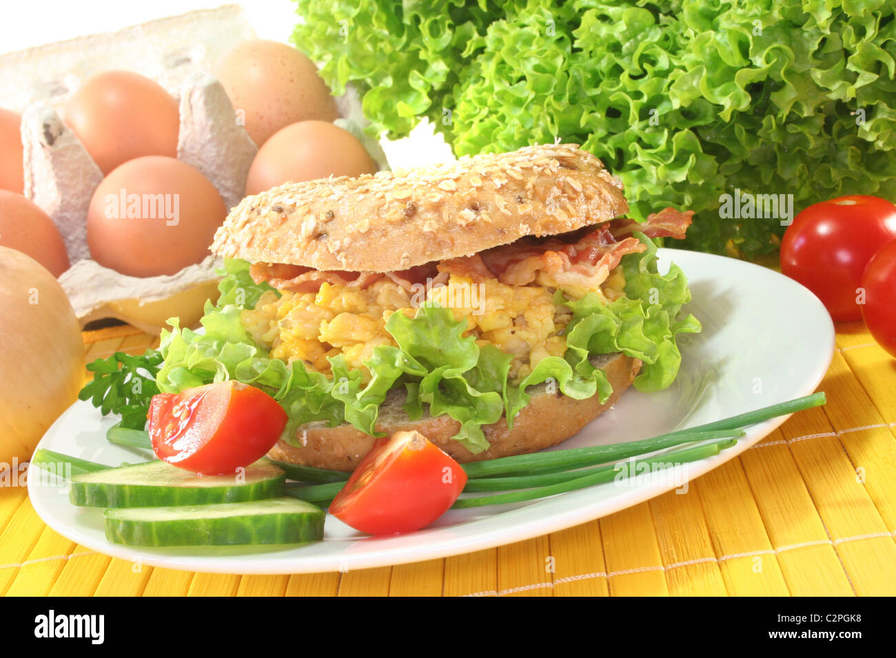 Rye bagel with salad, scrambled eggs and bacon Stock Photo - Alamy