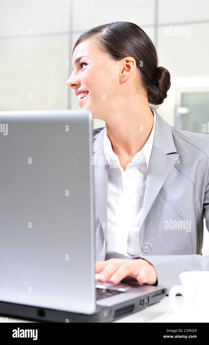 Beautiful happy and smiling business woman working on computer at her ...
