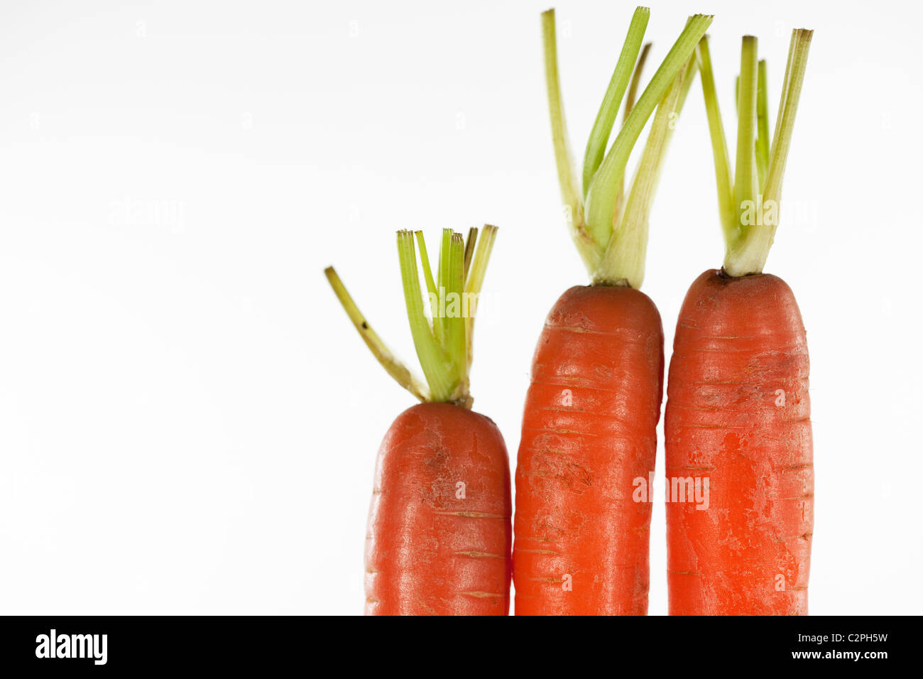 Three Carrots isolated on white Stock Photo - Alamy