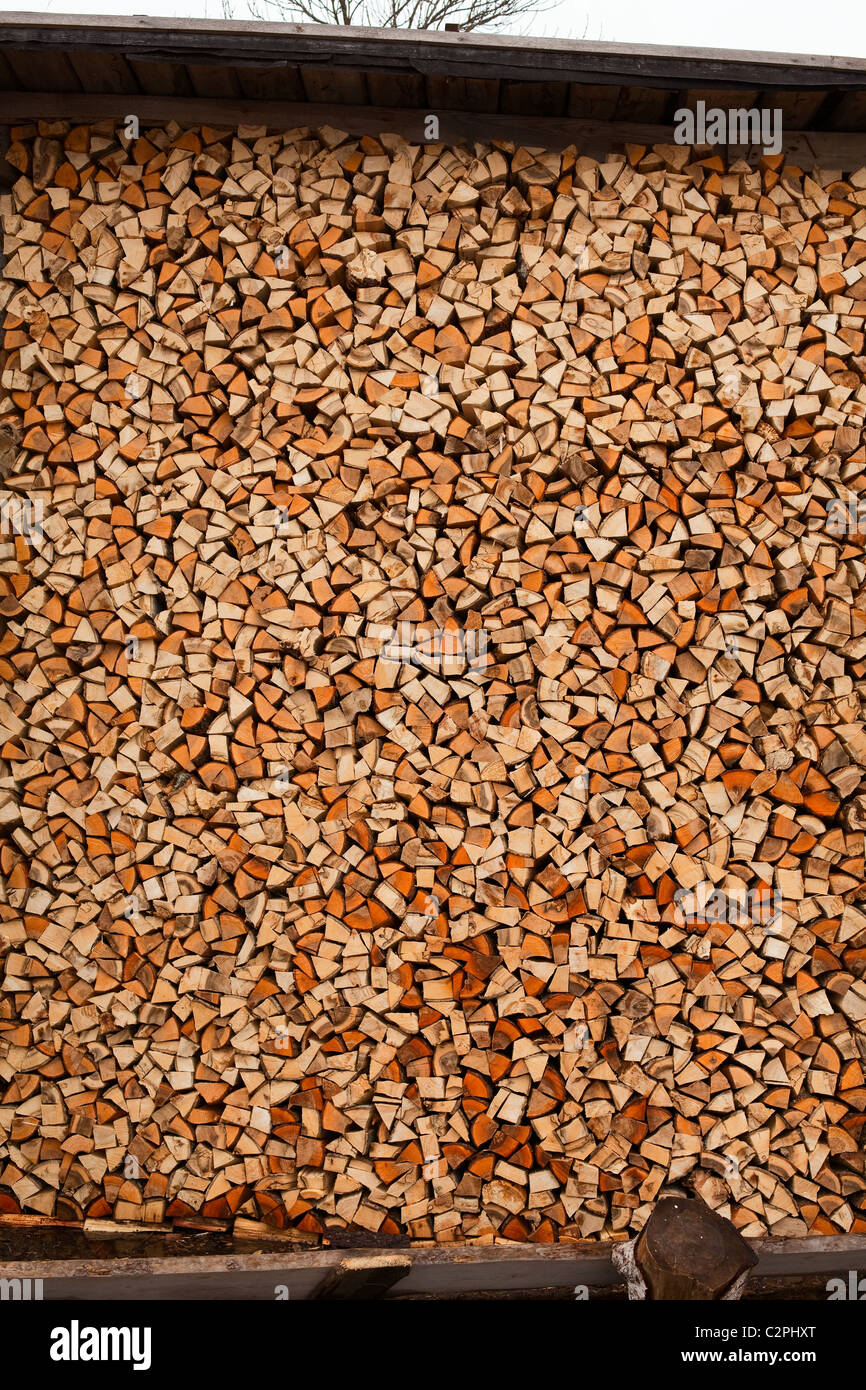 Big rural stack of firewood under roof in Russia. Woodshed Stock Photo ...