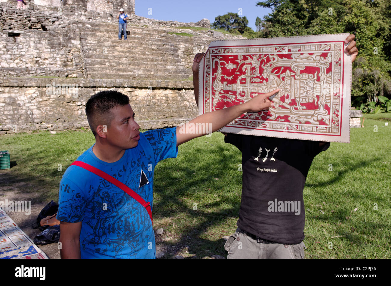 Mayan guide explaining a drawing of Pakal tomb to tourists in Palenque ...