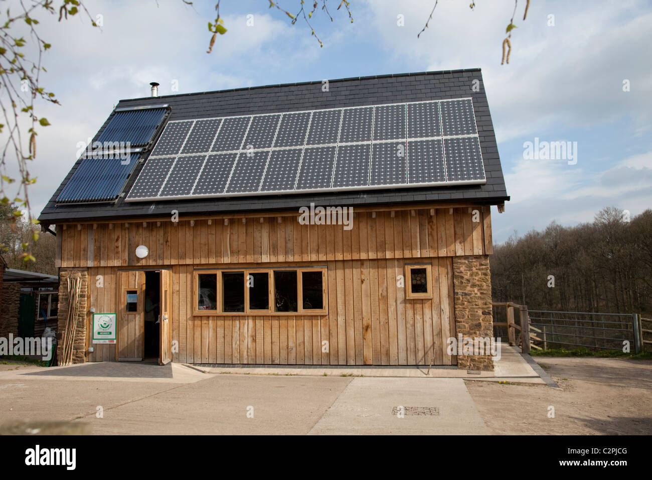 Solar thermal and PV panels on roof of sustainable oak timber building ...