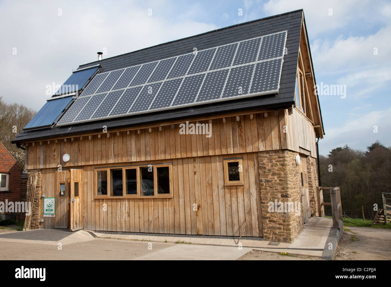 Solar thermal and PV panels on roof of sustainable oak timber building ...